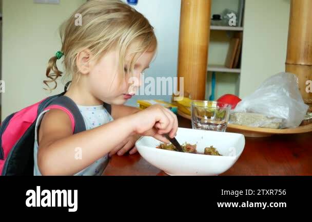 Side profile of little girl eating Stock Video Footage - Alamy