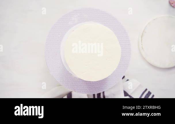 Step by step. Flat lay. Icing tall birthday cake with white buttercream ...