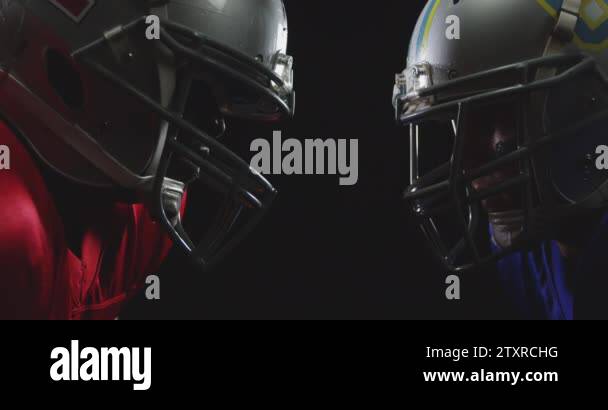 Side view of two American football players wearing team colours, pads ...
