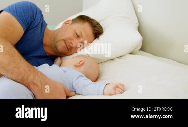Father and baby boy sleeping in bedroom at home 4k Stock Video Footage ...