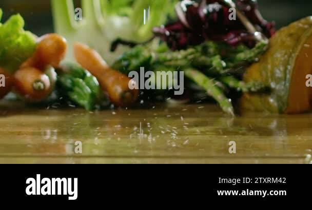 the expert hands of a young cook reveal some fresh vegetables very colored, legumes are ...