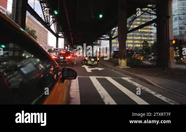 The famous yellow cab goes in a slow stream of cars under one of the ...