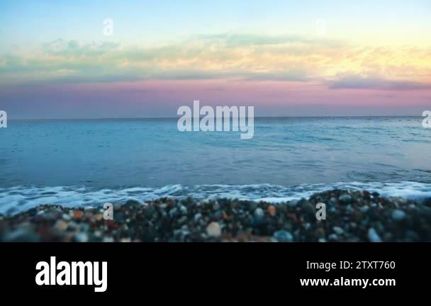 Sunset on greek pebble beach. Sea background Stock Video Footage - Alamy