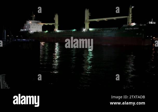 Night mooring of the cargo ship to the quay of the coal terminal. Port ...