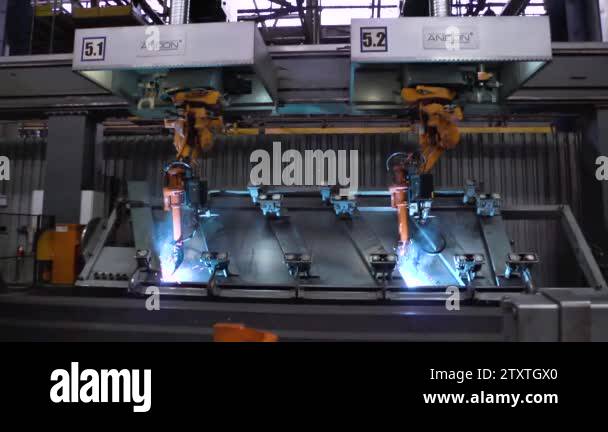 Welding robots movement in car factory. Scene. Movement of robot when ...