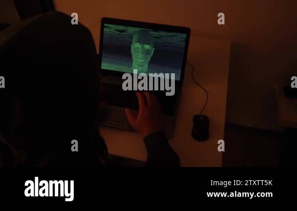 Hacker typing code in a dark room and creating artificial intelligence ...