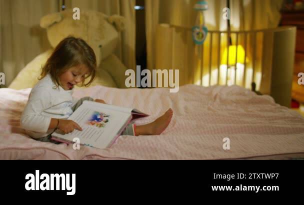 cheerful and happy little girls read a story in a book. happy child ...