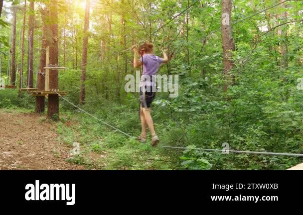 Small girl in adventure park. Adventure park is place which can contain wide variety of elements ...