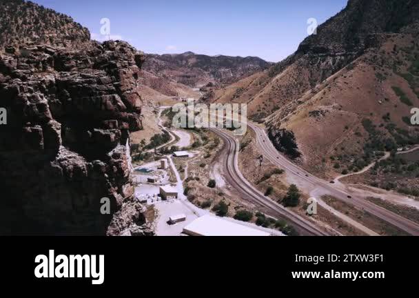 Drone flying close near big cliff to reveal beautiful highway road and ...
