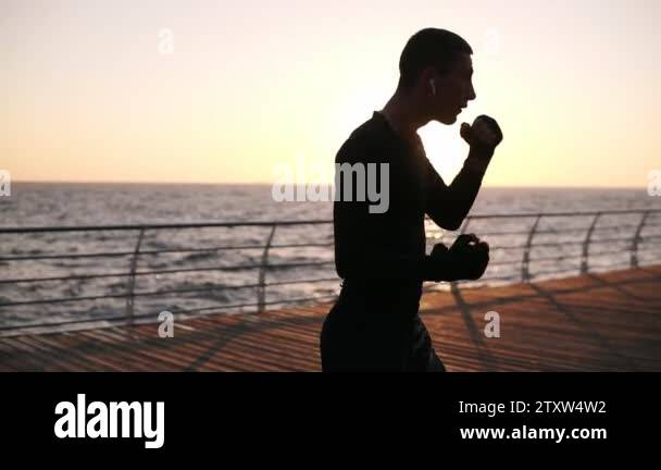 Gorgeous scene of a male boxer silhouette fighting with invisible ...
