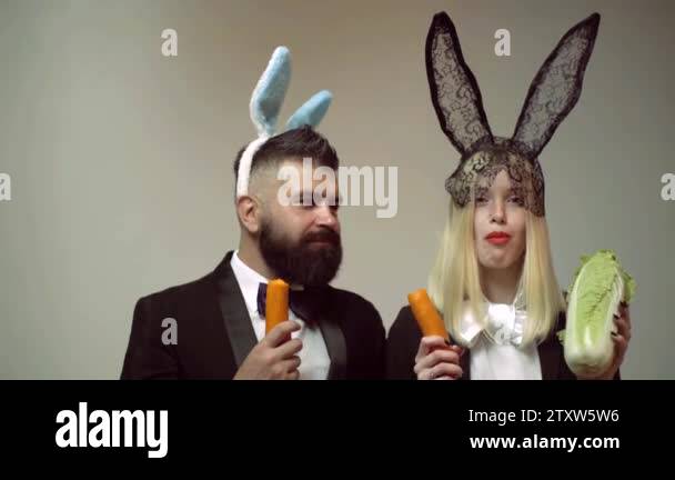 Rabbit couple eat carrot. Bunny ears concept with bunny couple. Heppy ...