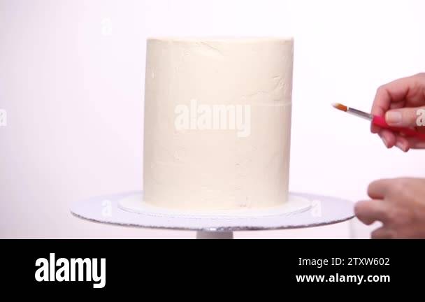 Step by step. Applying glitter dust on tall birthday cake with white ...