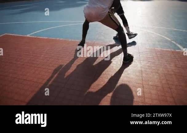 Low Camera View of Two Sportmens Have a Basketball Game, Bouncing ball ...