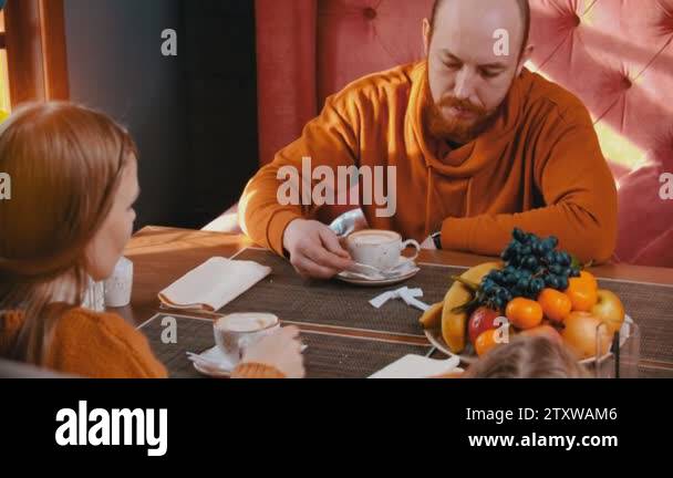 A family sitting in the hotel restaurant - parents of little girl ...