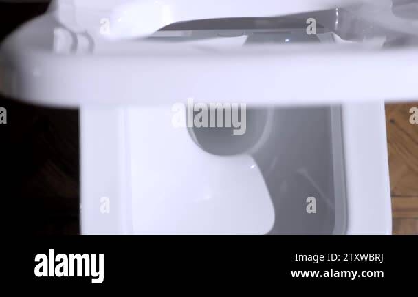 White automatic toilet. Modern technological solution. Raising the lid ...