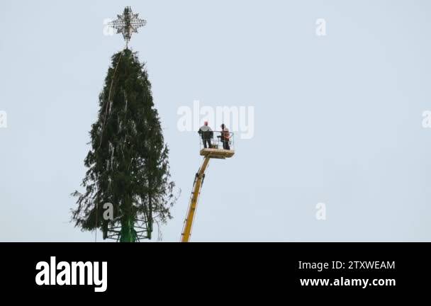 Workers disassemble a Christmas tree structure in the main central ...