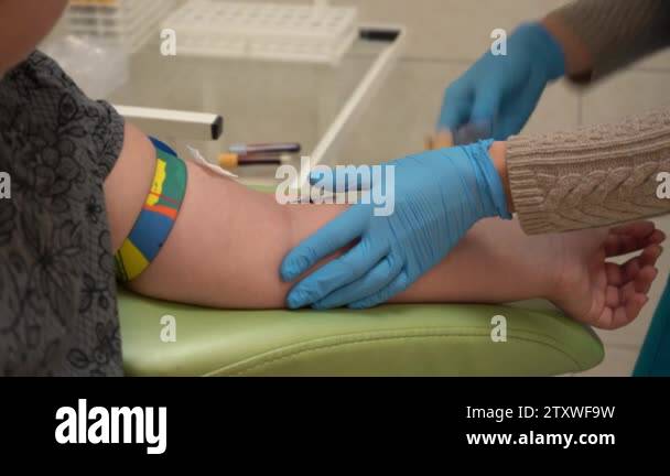 A teenage girl gives blood for analysis. Blood sampling from a vein ...