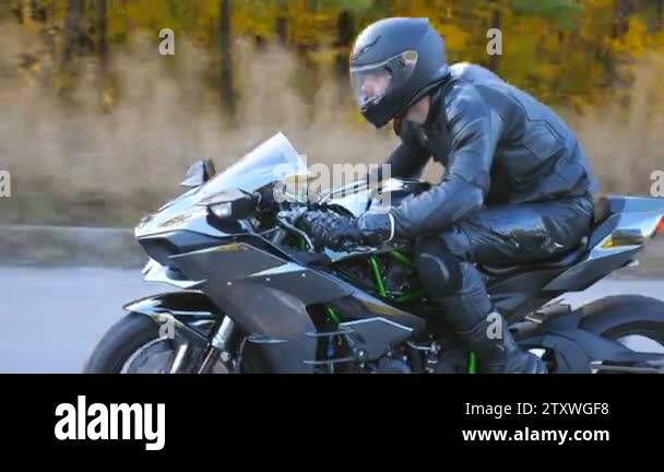 Motorcyclist racing his motorcycle on country road. Guy driving bike ...