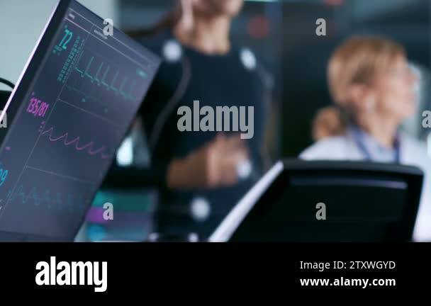 Monitor Showing EKG Reading of a Woman Athlete Running on a Treadmill ...