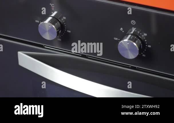 Metallic Toggle Switch of the Cooker Oven. Close-up View. Digital Clock ...