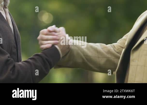 Best friends shaking hands and hugging meet each other outdoor, male ...