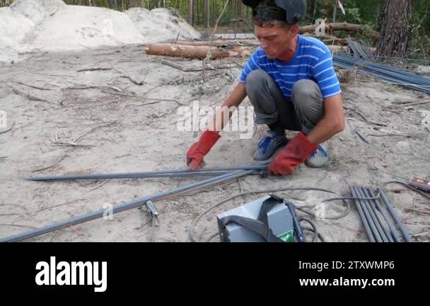 The welder lays out the rods for welding. A welder welds rods with an ...