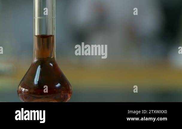 Amber lab flask Stock Video Footage - Alamy