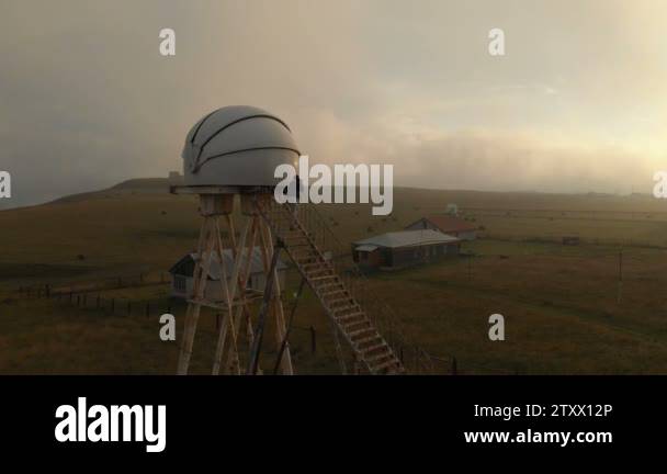 A traveler photographer girl stands on the ladder of an autonomous ...