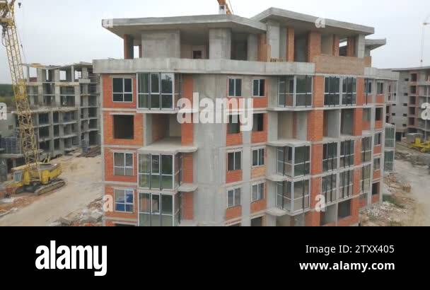 Flight above the construction site of the concrete frame of a multi ...