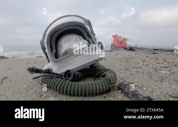 The head of a dead cosmonaut lies on the sand by the sea. Astronaut ...