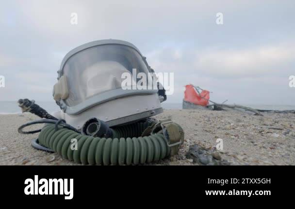 The head of a dead cosmonaut lies on the sand by the sea. Astronaut ...