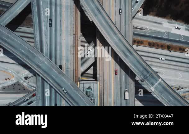 top view drone zooming out on large highway intersection with cars ...