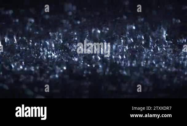 Heavy rain falling in front of the camera against black screen ...