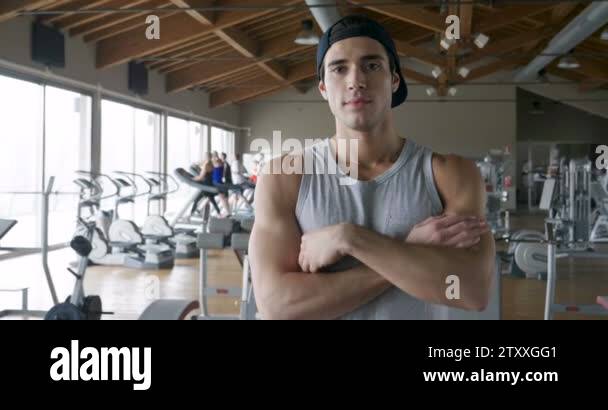 A shirtless guy at the gym, trains his body to stay fit and have ...
