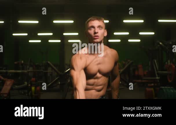 Handsome strong athletic men pumping up shoulders muscles workout ...