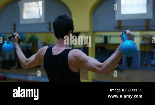 Guy bodybuilder in the gym, works with a barbell, bench press ...