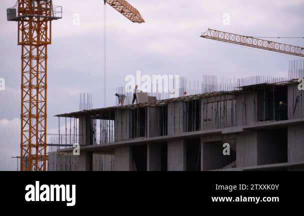 Builders on the Edge of a Skyscraper Under Construction. Workers at a ...