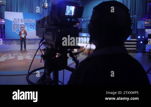 Cameraman with a camera in a TV studio while recording TV broadcasts ...
