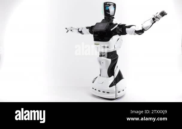 Modern Robotic Technologies. Robot in the bright studio. Android raises ...