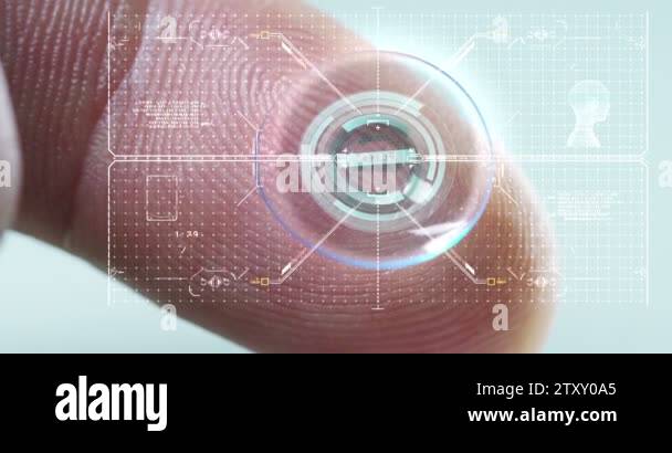 Macro shot of a finger holding a contact lens technology with a chip to ...