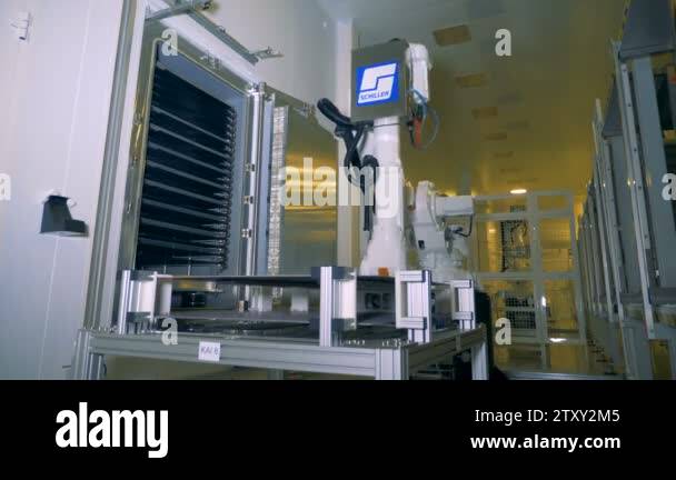 Factory equipment, robotic arm moving big solar panels, close up Stock ...