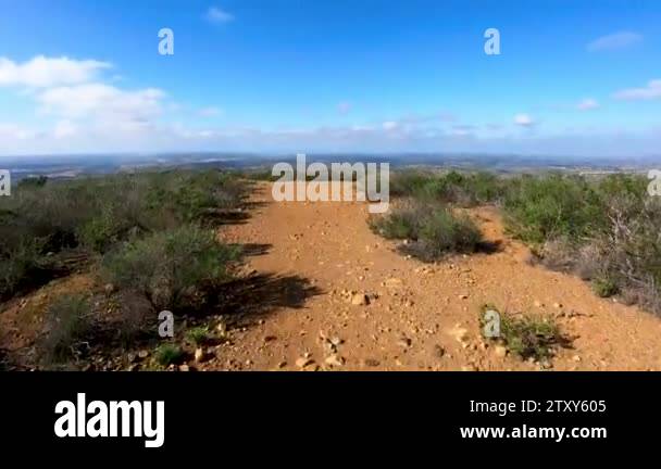 Walking through small trails to the top of the Black Mountain in San ...
