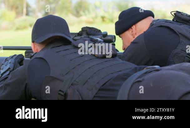 Rear view of caucasian military soldiers looking through binoculars and ...