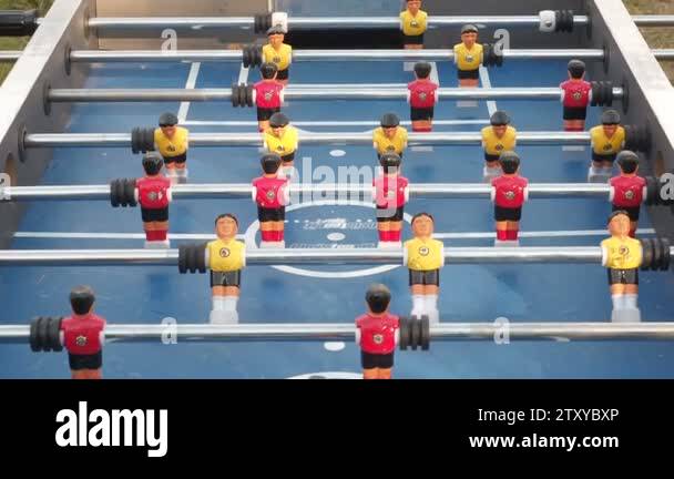 Figures of footballers move left and right people playing foosball ...