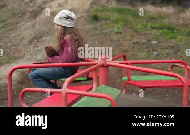 Crying sad little homeless girl whirling on the carouesel Stock Video ...