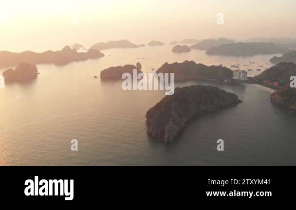 Aerial: unique flying over Ha Long Bay and Cat Ba island at sunset ...