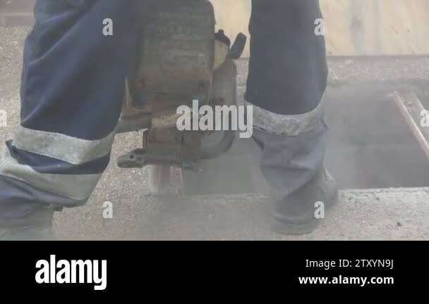 Footage of a workman using an angle grinder on a manhole cover Stock ...