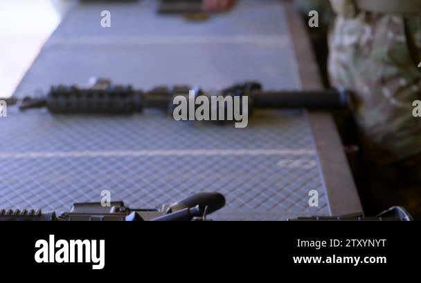 Side view of caucasian military soldiers loading weapon during training ...