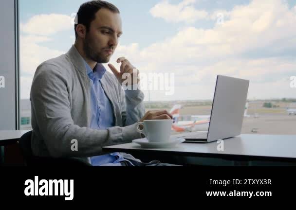 Man thinking while waiting for his flight in the international airport ...