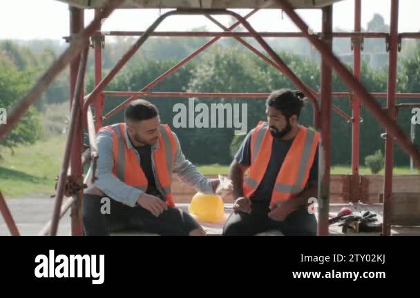 People working in construction site. Men at work in new house inside ...